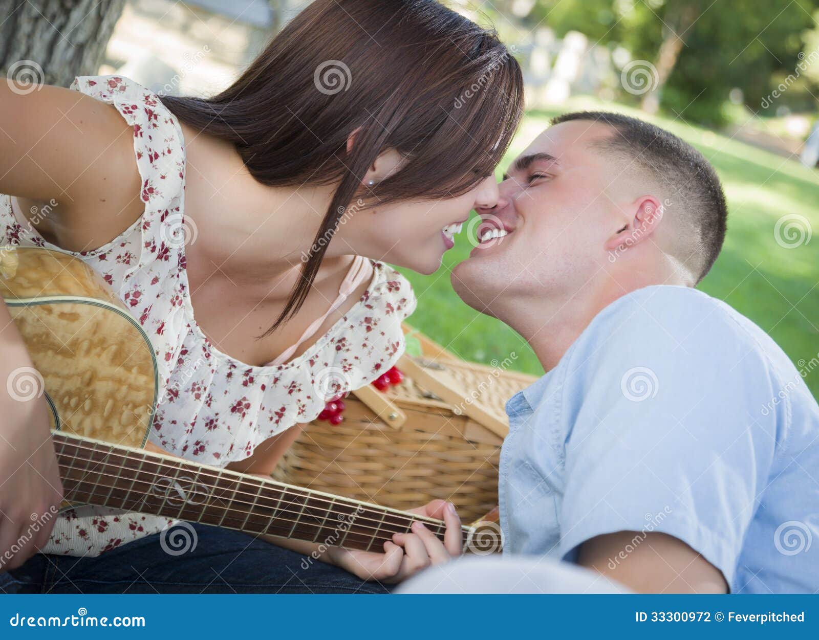 Mixed Race Couple with Guitar Kissing in the Park Stock Photo - Image ...