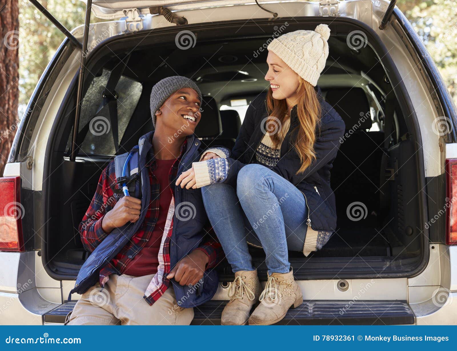 Mixed Race Couple in Open Back of Car Looking at Each Other Stock Image ...
