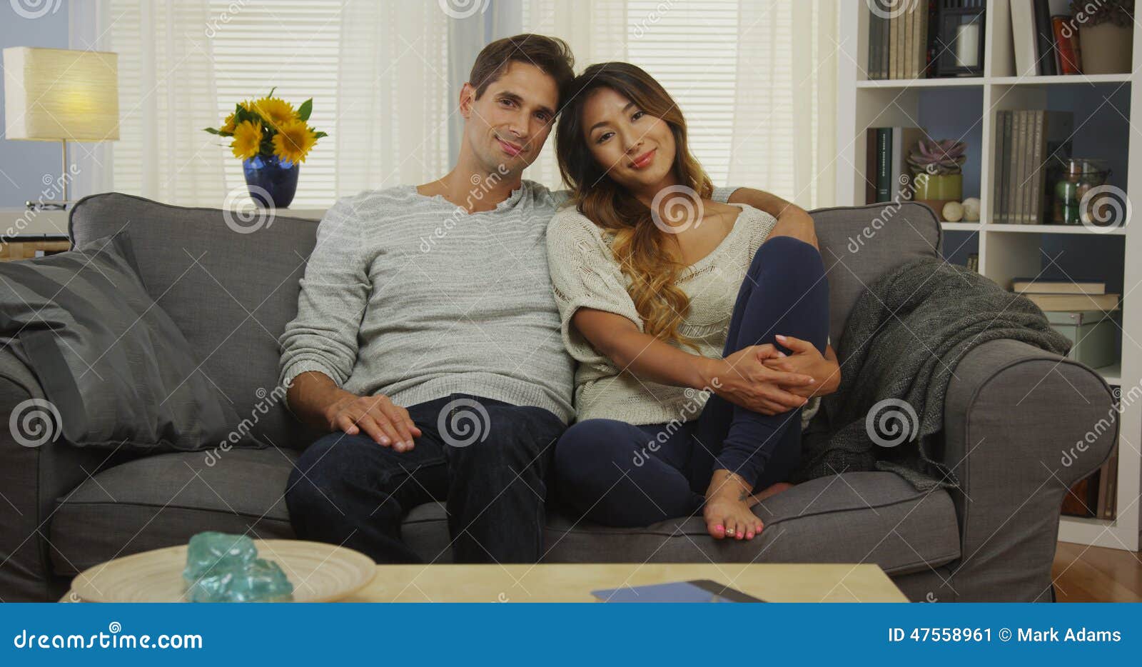 Mixed Race Couple Sitting On Couch Smiling Stock Image Image Of