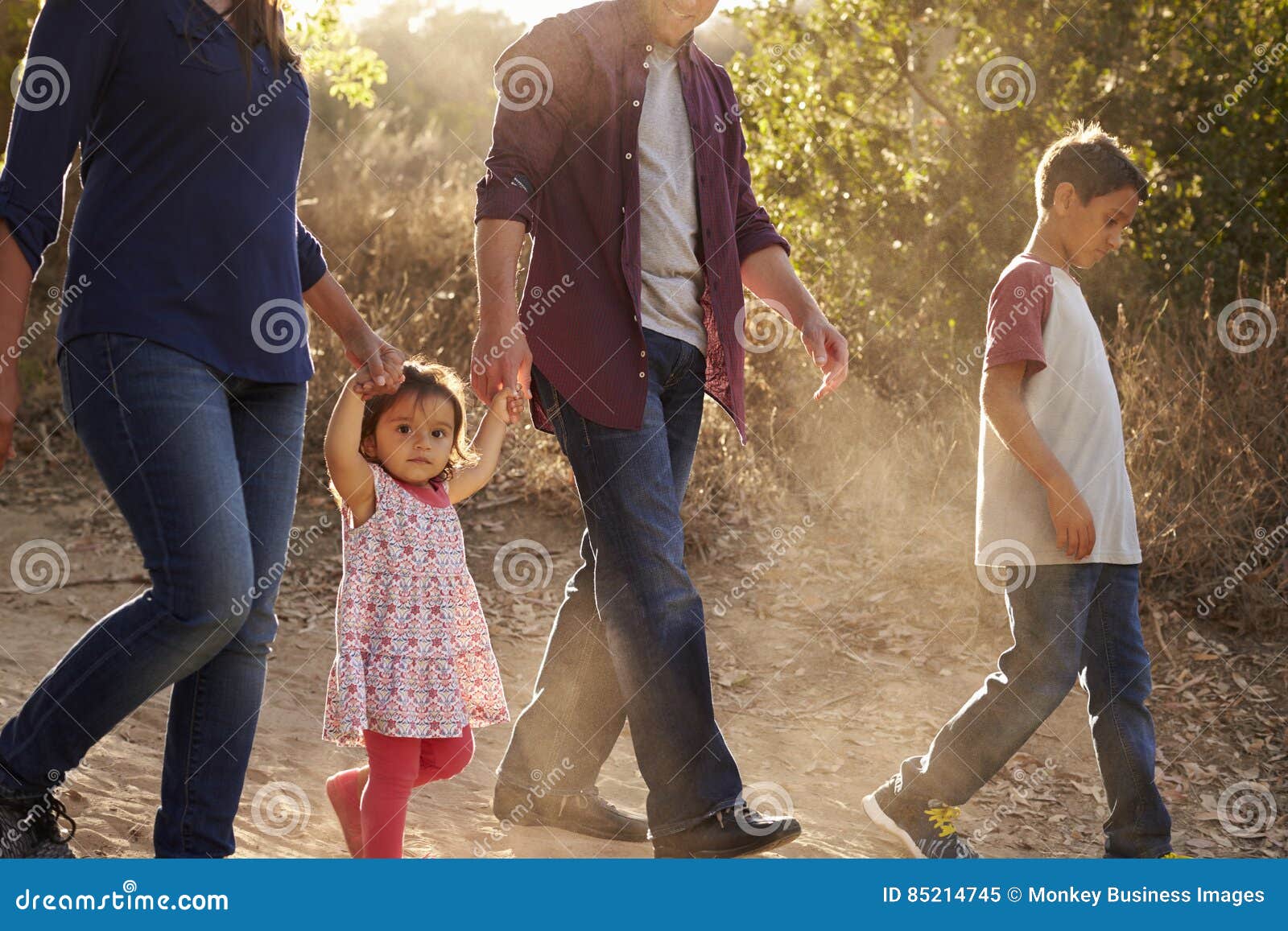 Mixed Race Family Walking On Rural Path, Close Up Side View Royalty ...
