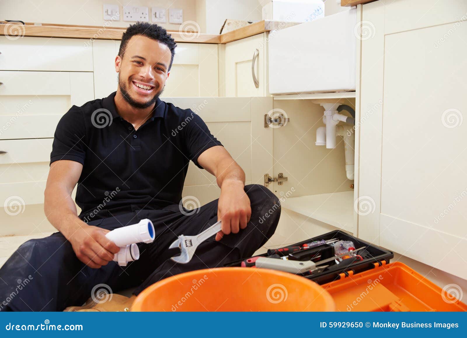 Mixed Race Plumber Sitting in a Kitchen, Portrait Stock Photo - Image ...