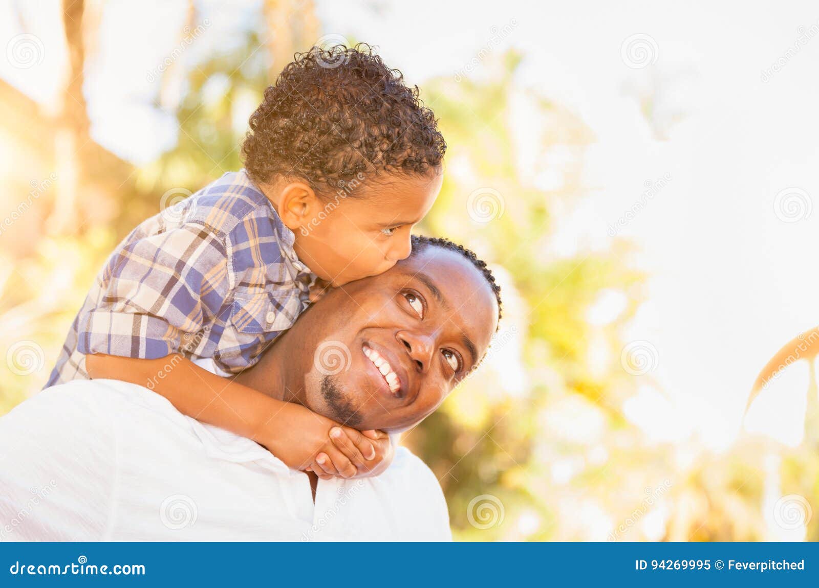Mixed Race Son And African American Father Playing Outdoors Together