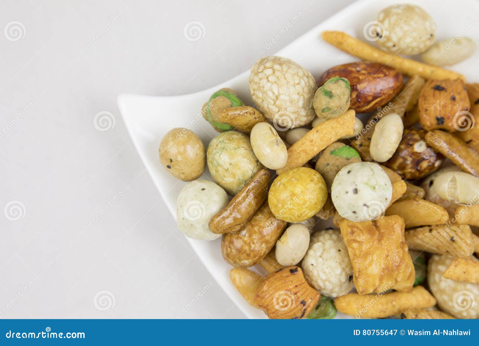 Mixed Snacks Rice, Nuts and Dried Green Beans on a White Plate Stock ...