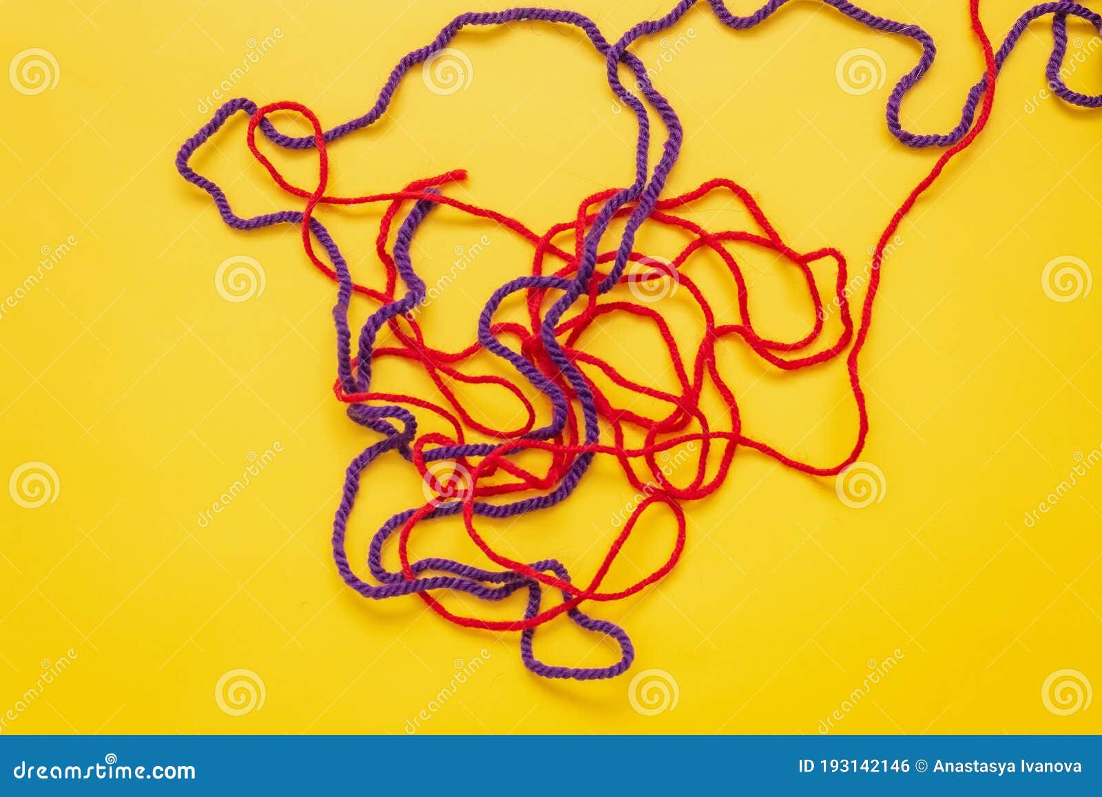 Mixed Up Red and Blue Wool Threads Lie on a Yellow Background Stock ...