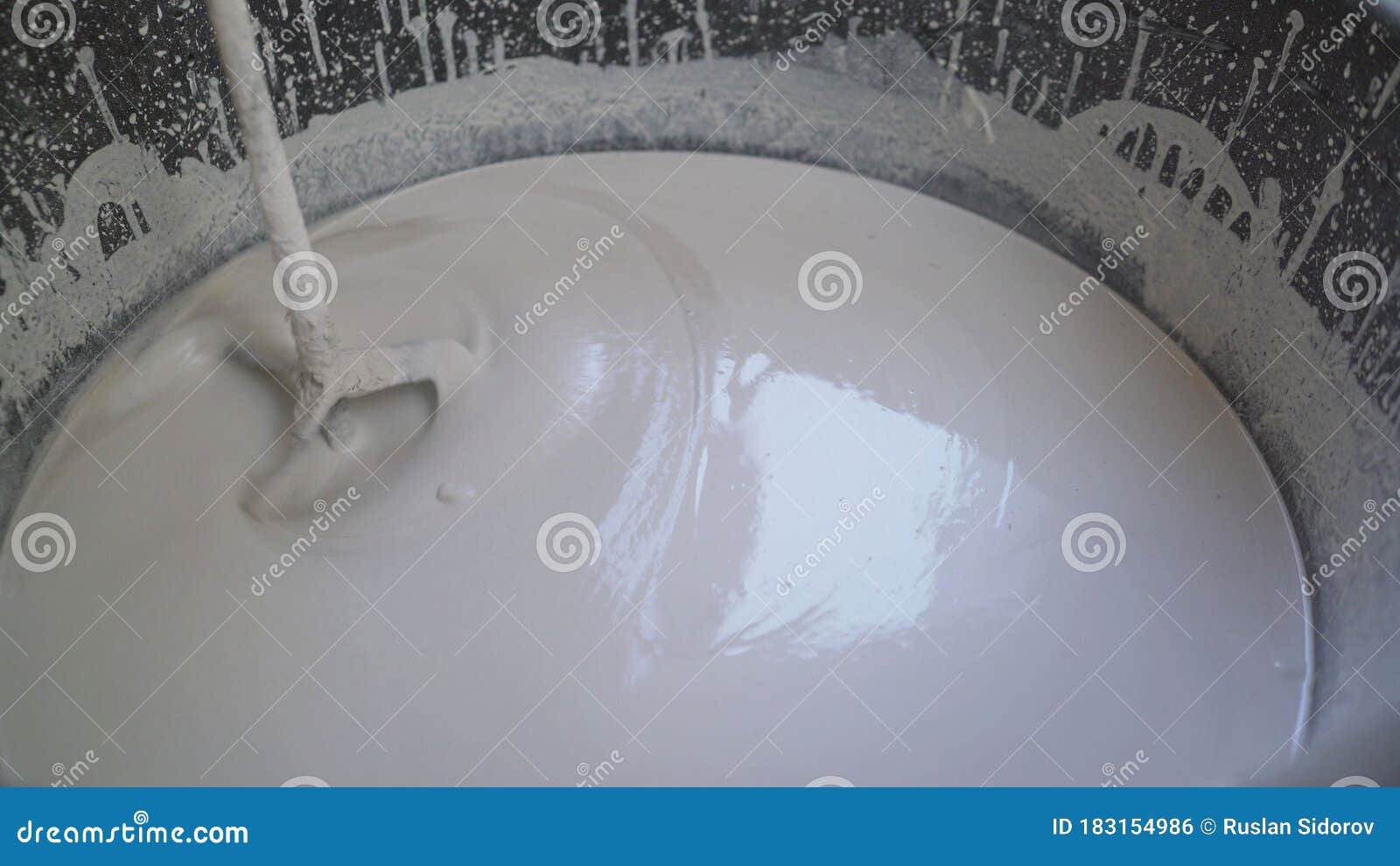 The Primer is Mixed in a Large Bucket Using a Construction Mixer. the ...