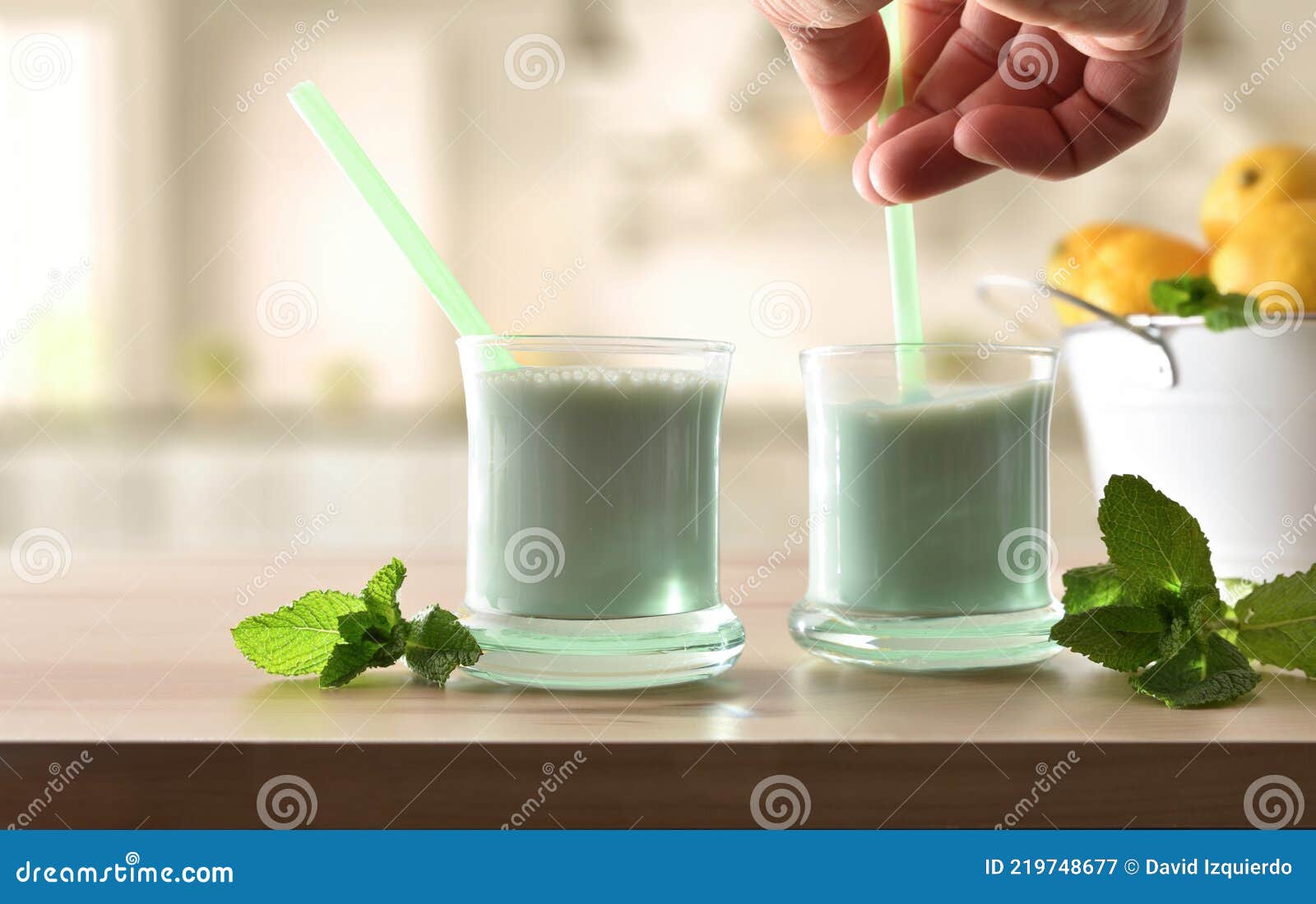 Mixing Mint Milk Drink with a Straw on Kitchen Bench Stock Image ...