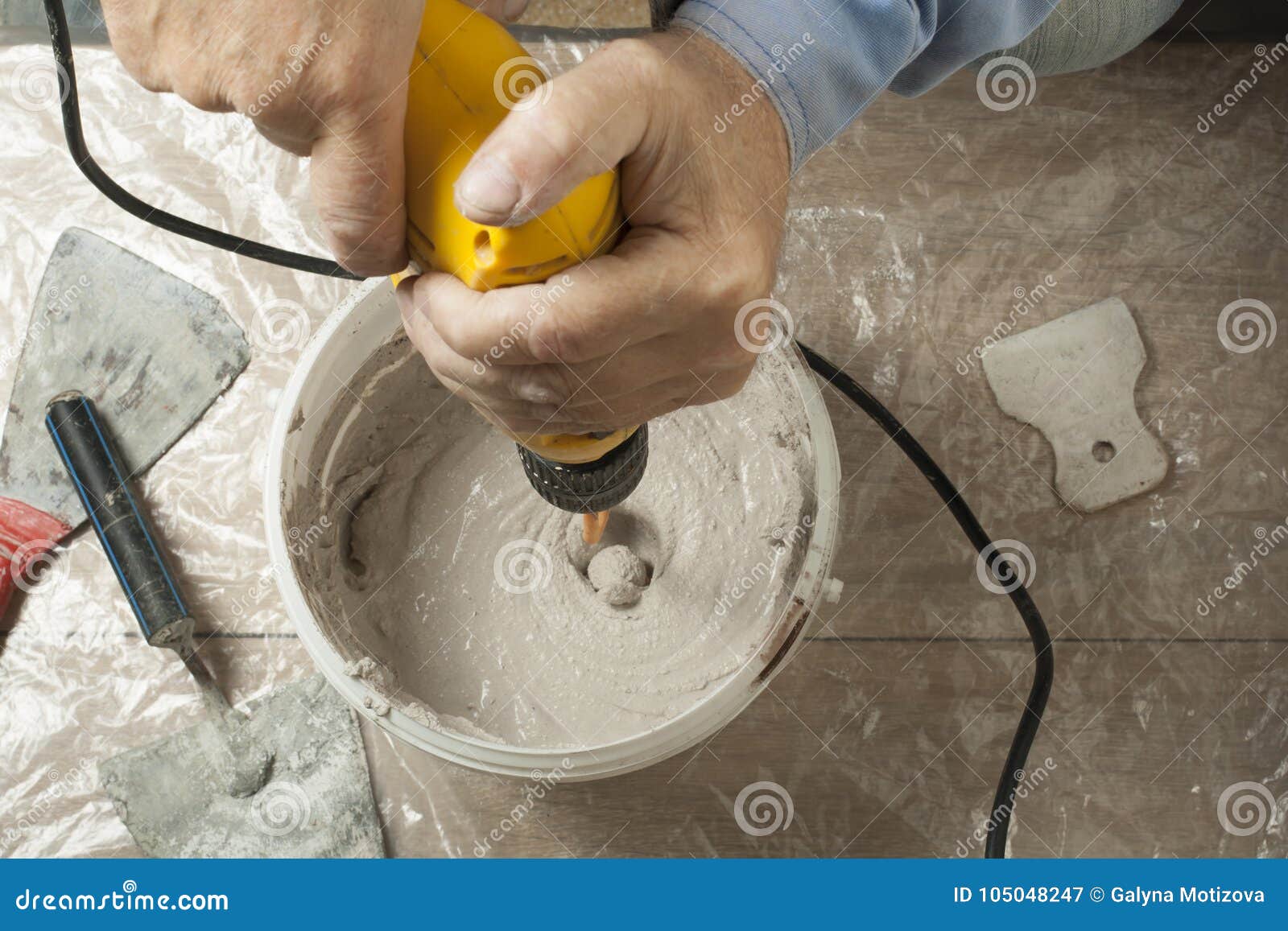 Mixing Plaster Solution in a Bucket,using Electric Drill Stock Image ...