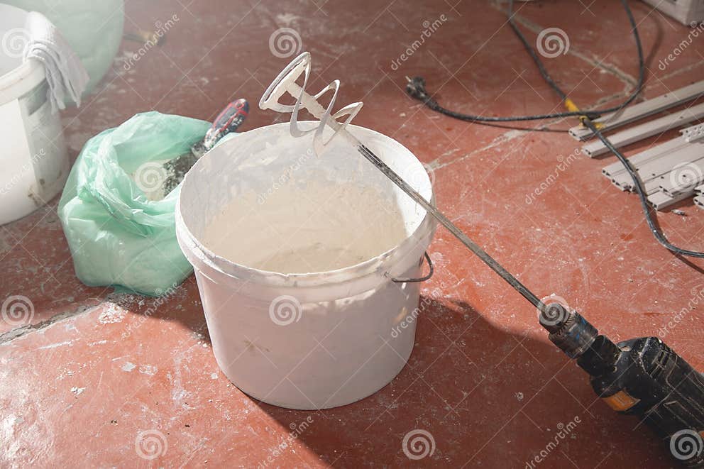 Mixing of Putty. Construction Mixer in a Bucket Stock Photo - Image of ...