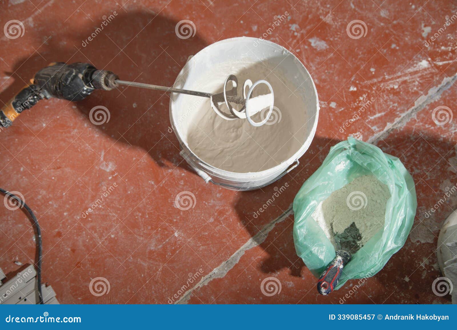 Mixing of Putty. Construction Mixer in a Bucket Stock Image - Image of ...