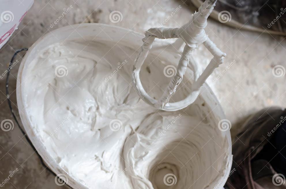 Mixing Putty Solution in a Pail. Construction Works Stock Photo - Image ...