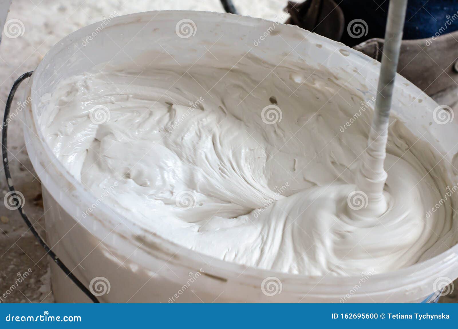 Mixing Putty Solution in a Pail. Construction Works Stock Photo - Image ...
