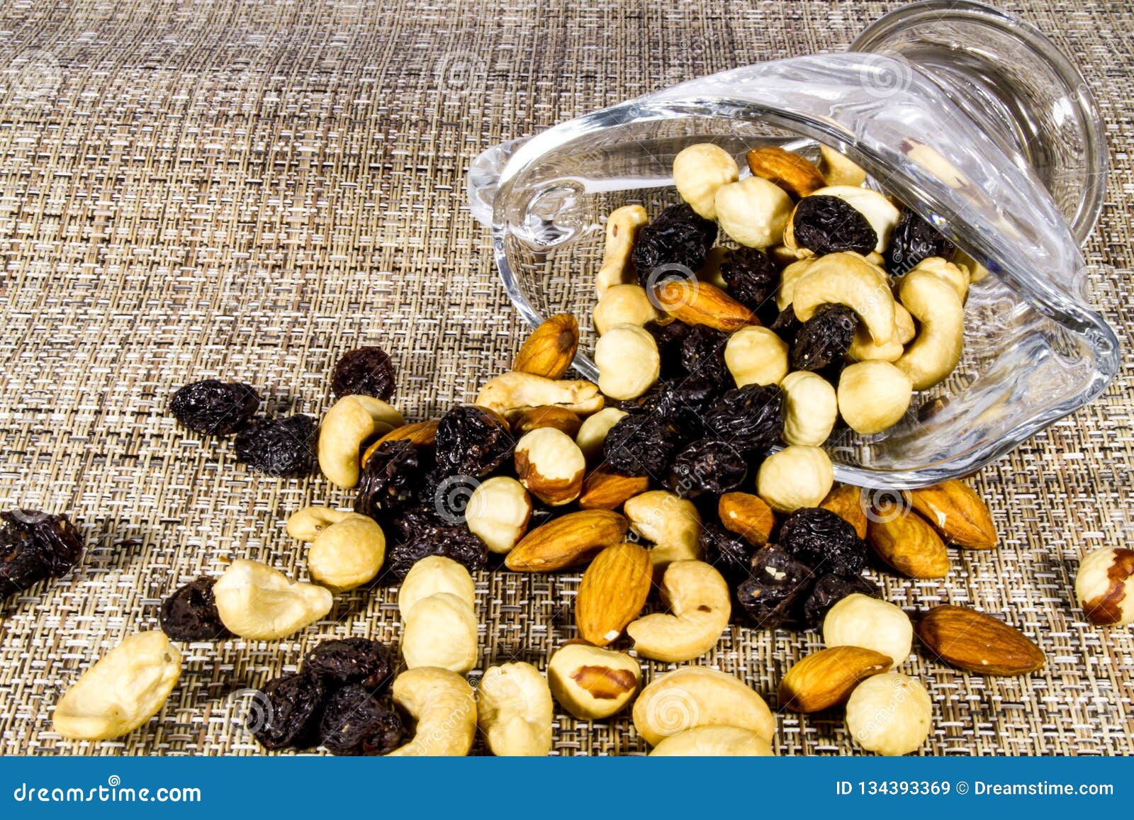 A Mixture of Nuts and Dried Grapes Scattered on a Glass Table Stock ...