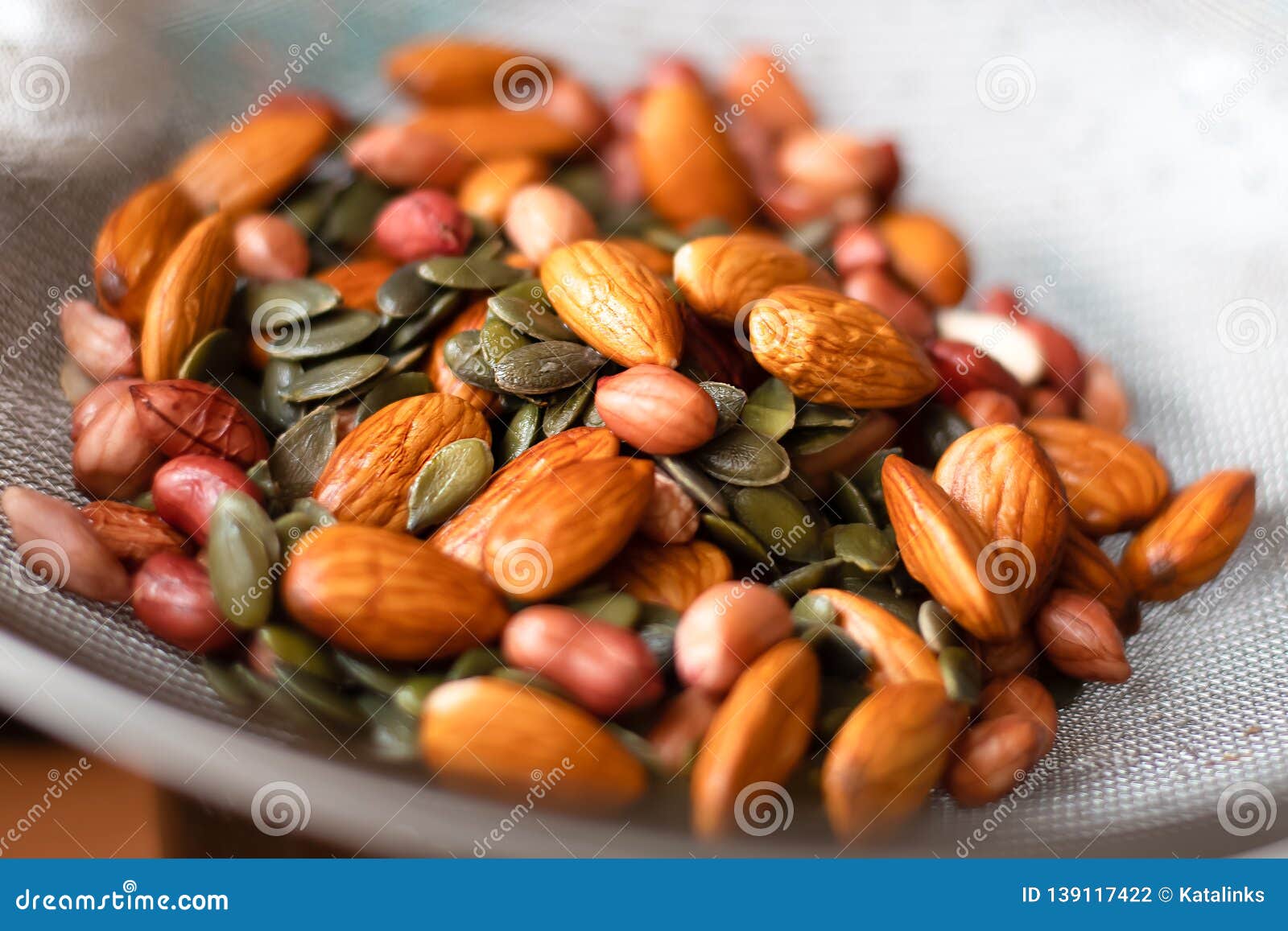A Mixture of Wet Washed Nuts and Seeds on the Sieve. Peanuts, Pumpkin ...