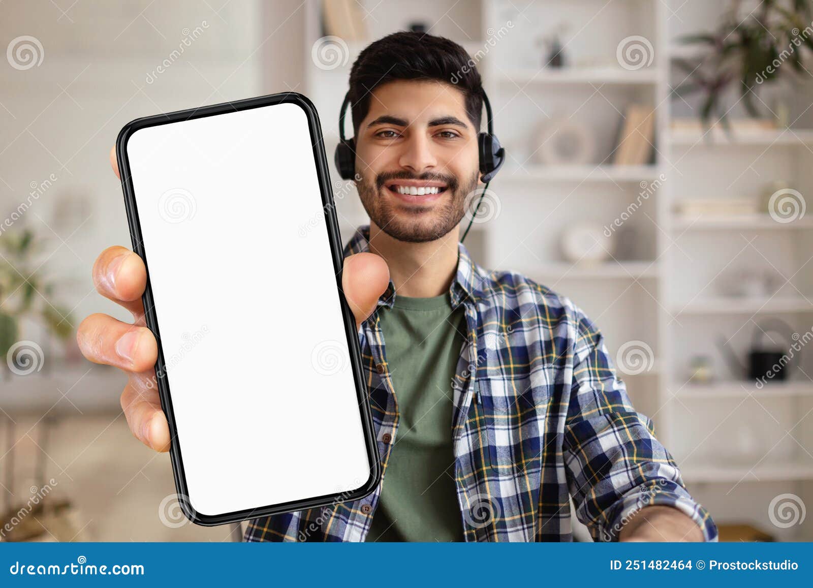 Mobile Advertisement. Cheerful Arab Guy in Headset Holding Big Blank ... Mobile Advertisement. Cheerful Arab Guy in Headset Holding Big Blank ...