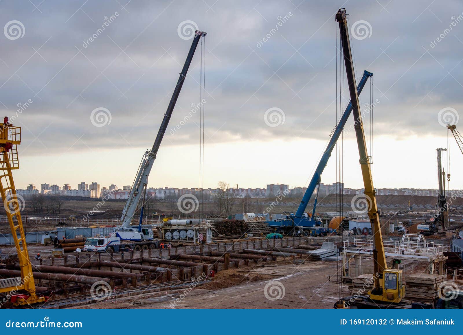 Mobile Auto Cranes Working at Construction Site. Digging a Pit for the ...