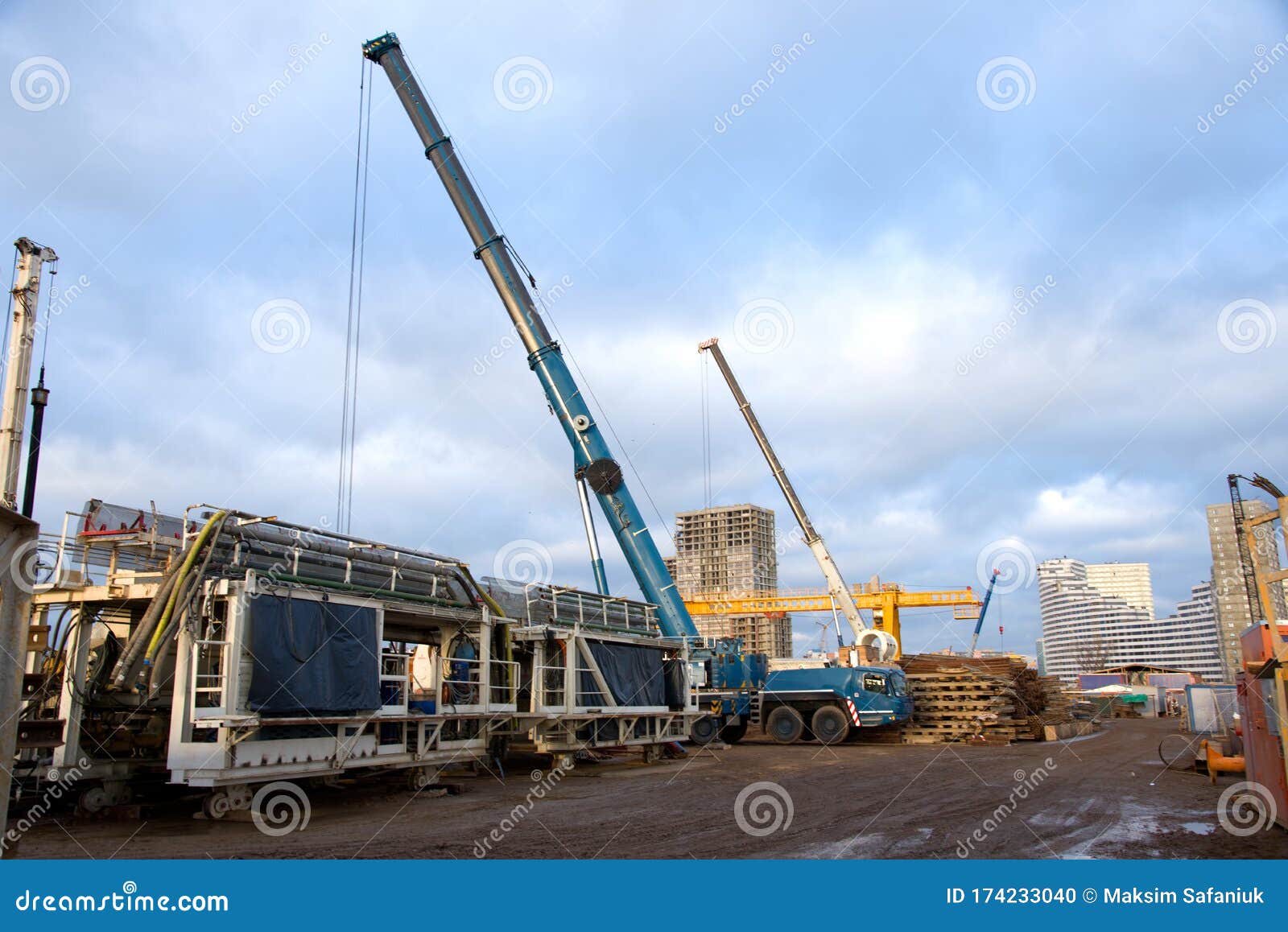 Mobile Auto Cranes Working at Construction Site. Digging a Pit for the ...