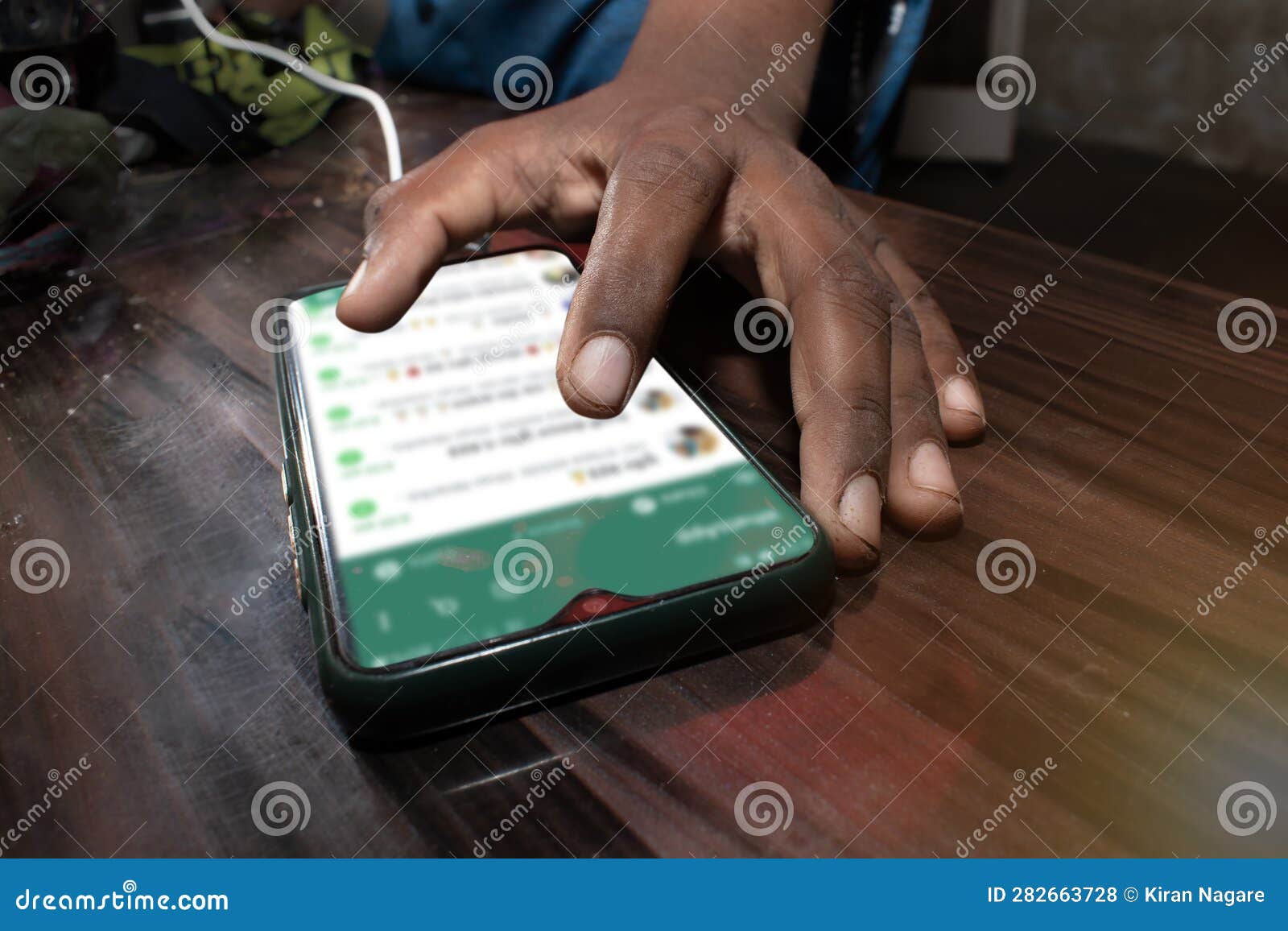 The Mobile Being Used by the Hand, the Mobile is Placed on the Table ...