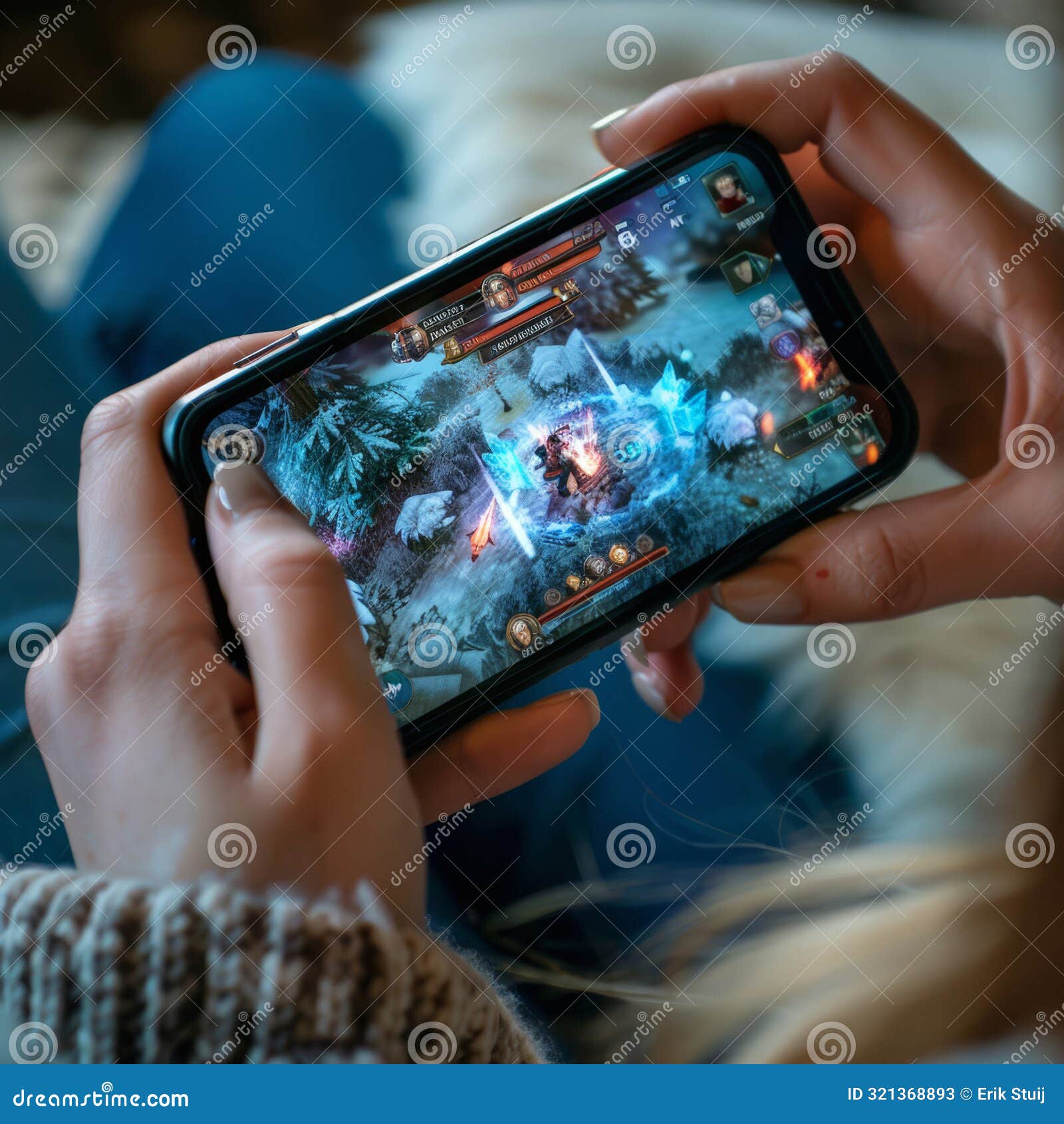 Mobile Gaming Concept: Hands with a Smartphone with Game on Screen ...
