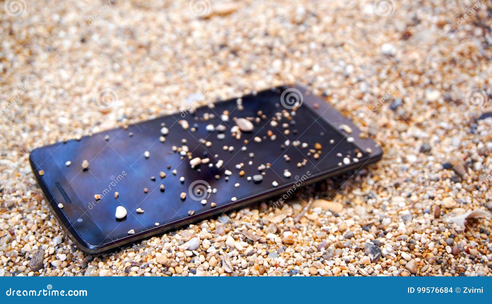 A mobile phone in the sand stock photo. Image of buttons - 99576684