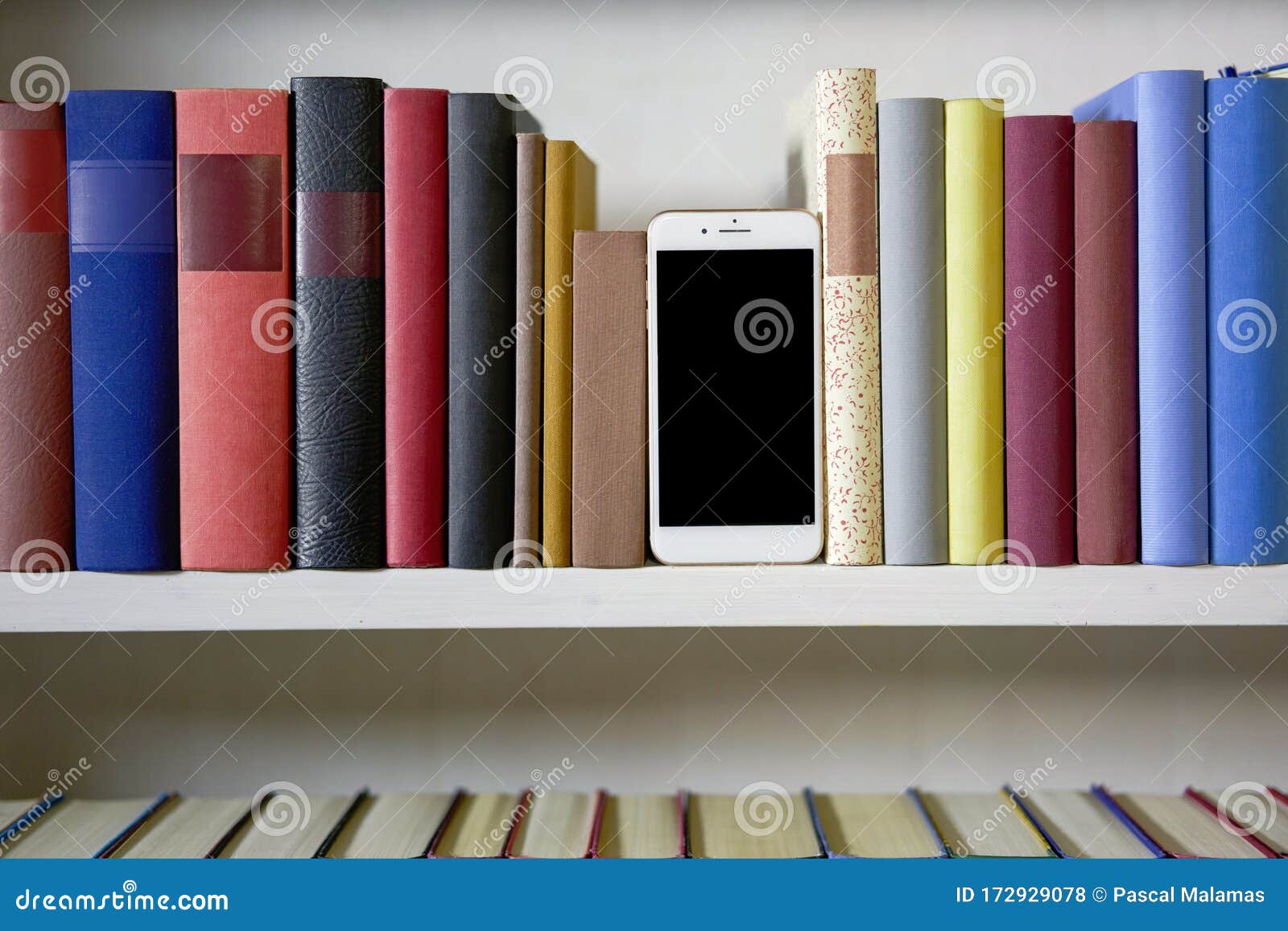Mobile Phone in Bookshelf with Sorted Books Stock Photo - Image of ...