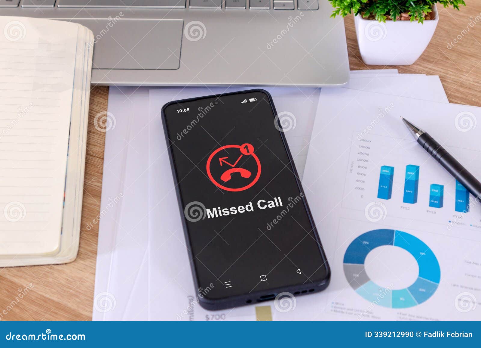 A Mobile Phone on a Desk with a Missed Call Notification on the Phone ...