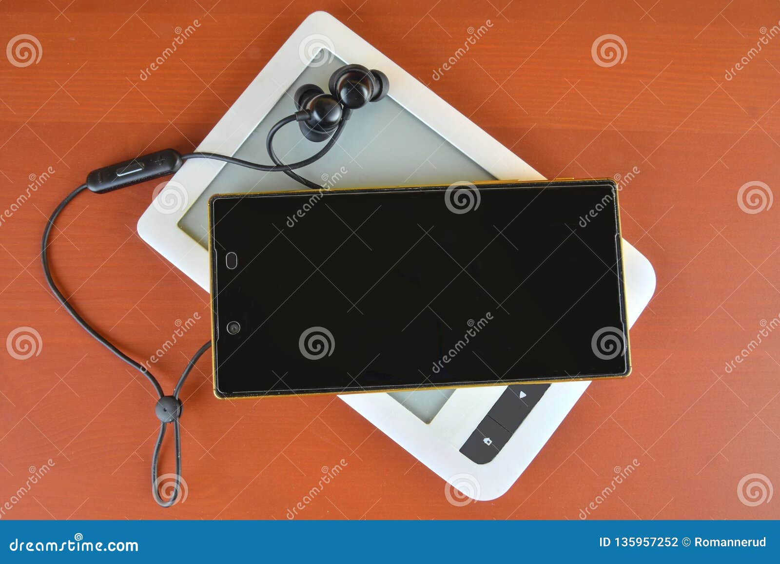 Mobile Phone, E-book-reader and Wireless Headset on Claret Background ...