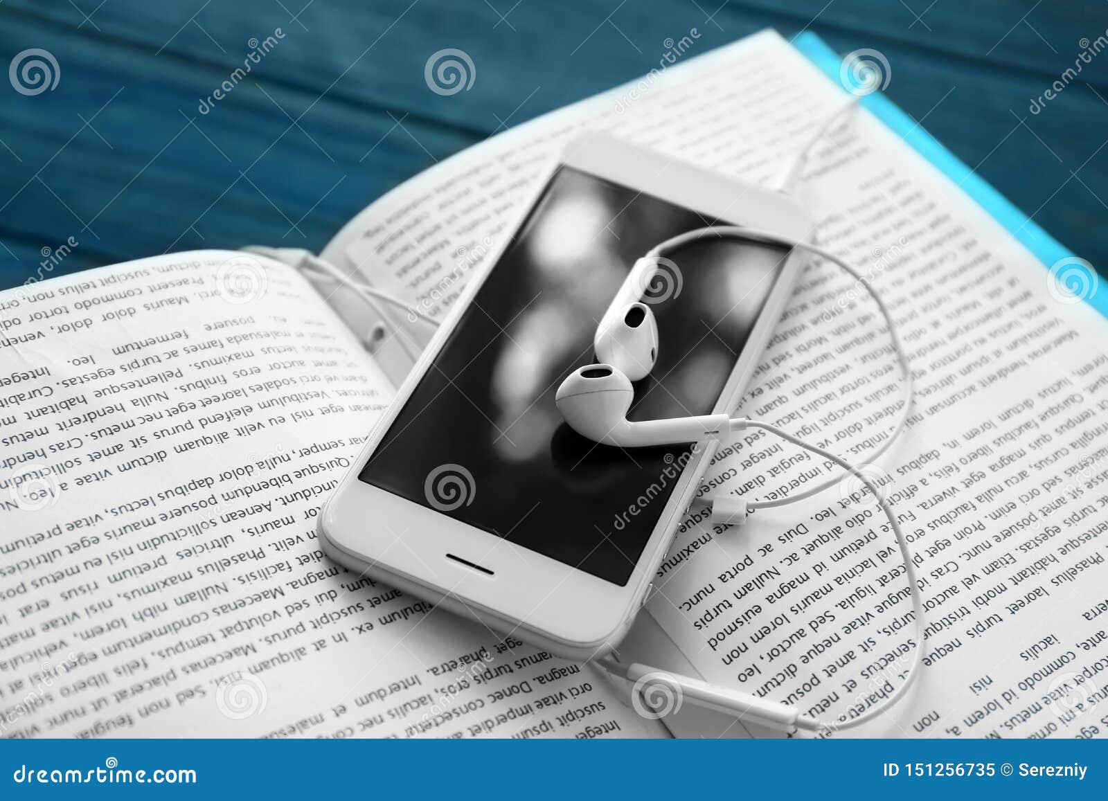 Mobile Phone with Earphones on Open Book, Closeup Stock Image - Image ...