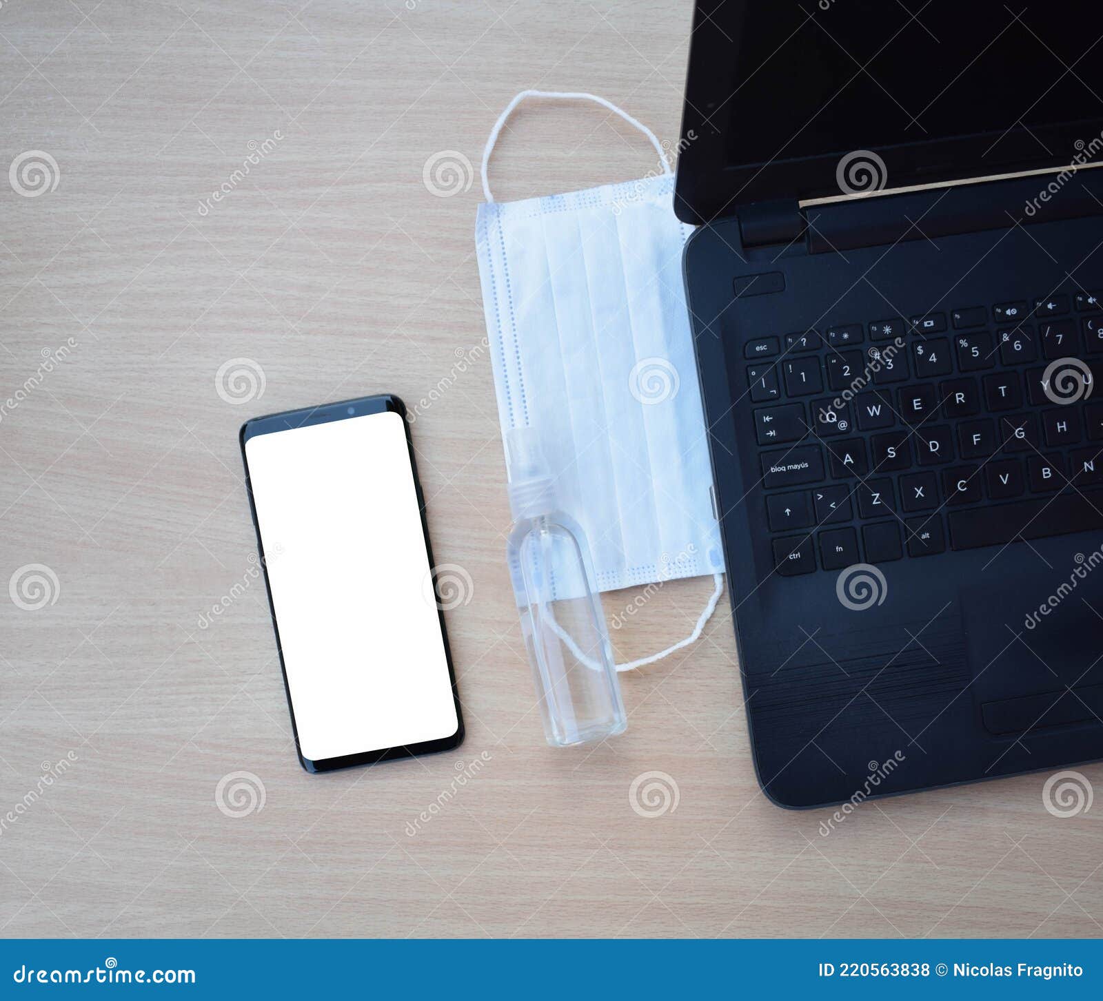 Mobile Phone with Face Mask on the Workspace of the Work Table. Top ...