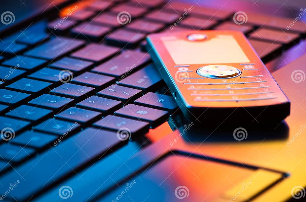 Mobile phone on keyboard stock image. Image of notebook - 12573311