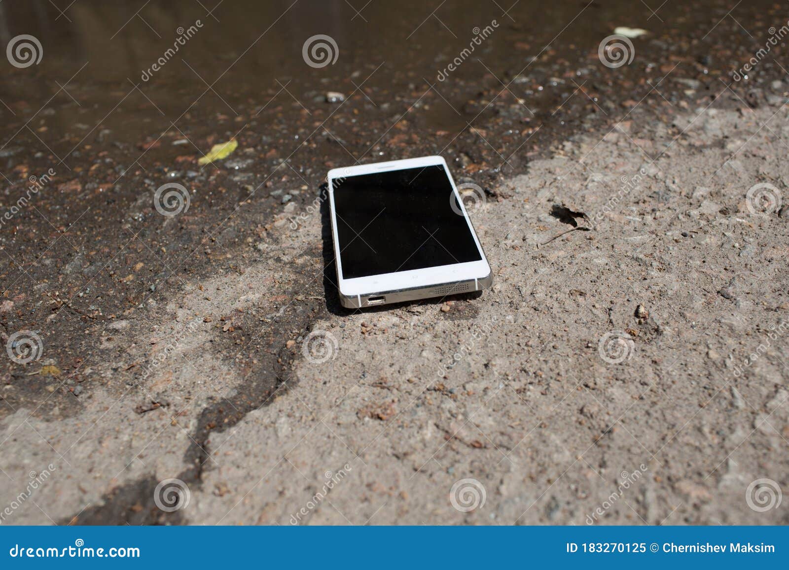 Mobile Phone Lying on Pavement in Puddle/ Stock Image - Image of ...