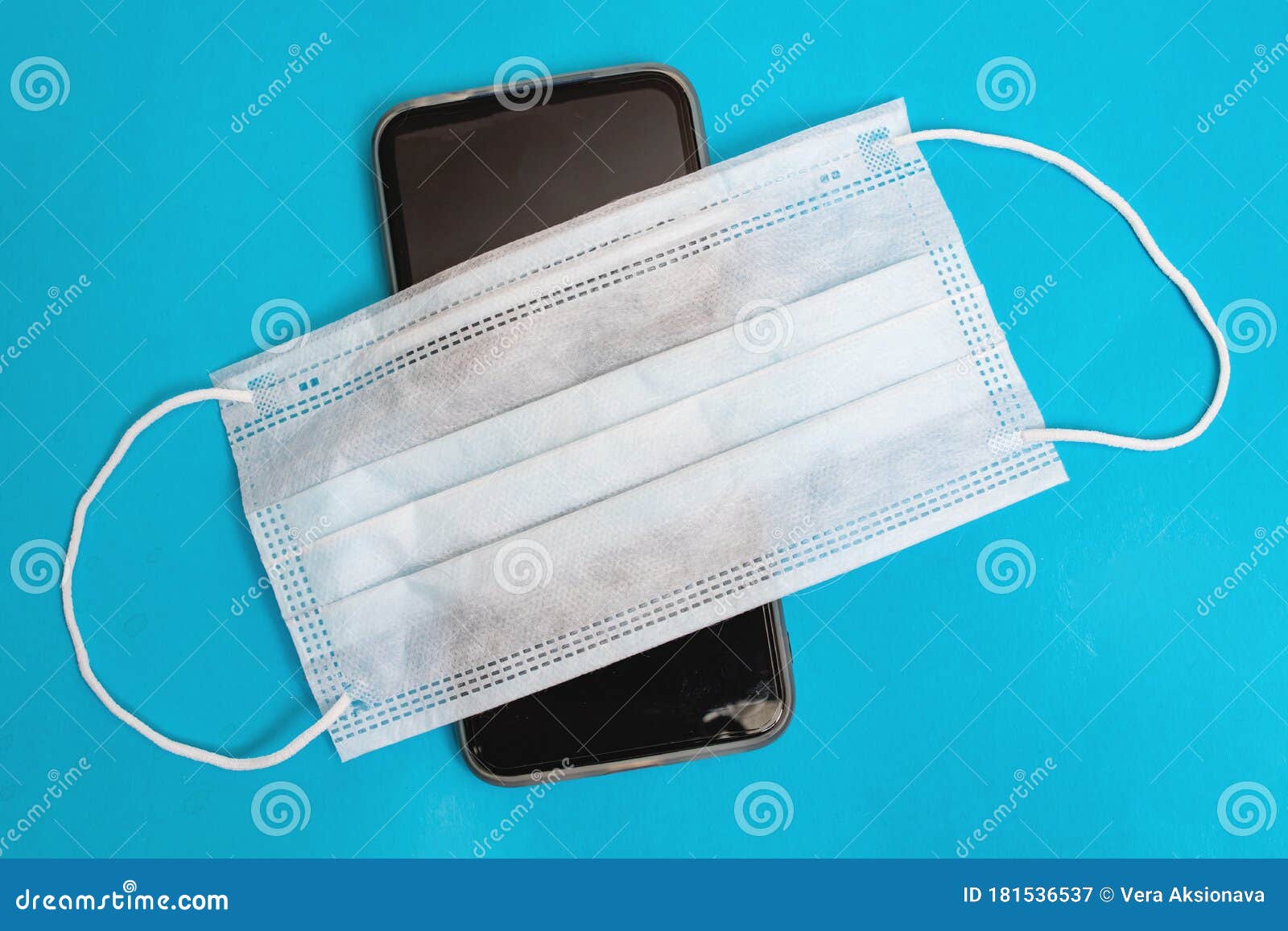 Mobile Phone in Medical Mask on Blue Background Stock Image - Image of ...