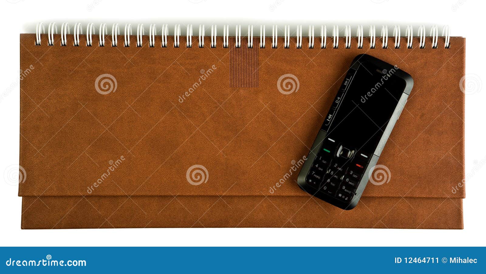 Mobile phone on a notebook stock image. Image of phone - 12464711