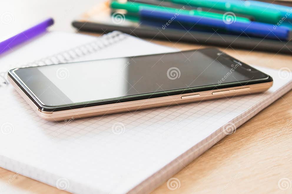 A Mobile Phone and a Notebook are on the Table Stock Image - Image of ...