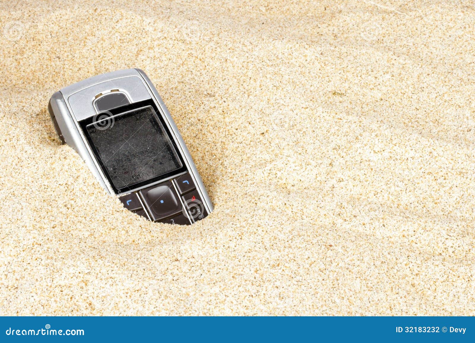 Mobile phone in the sand stock photo. Image of global - 32183232