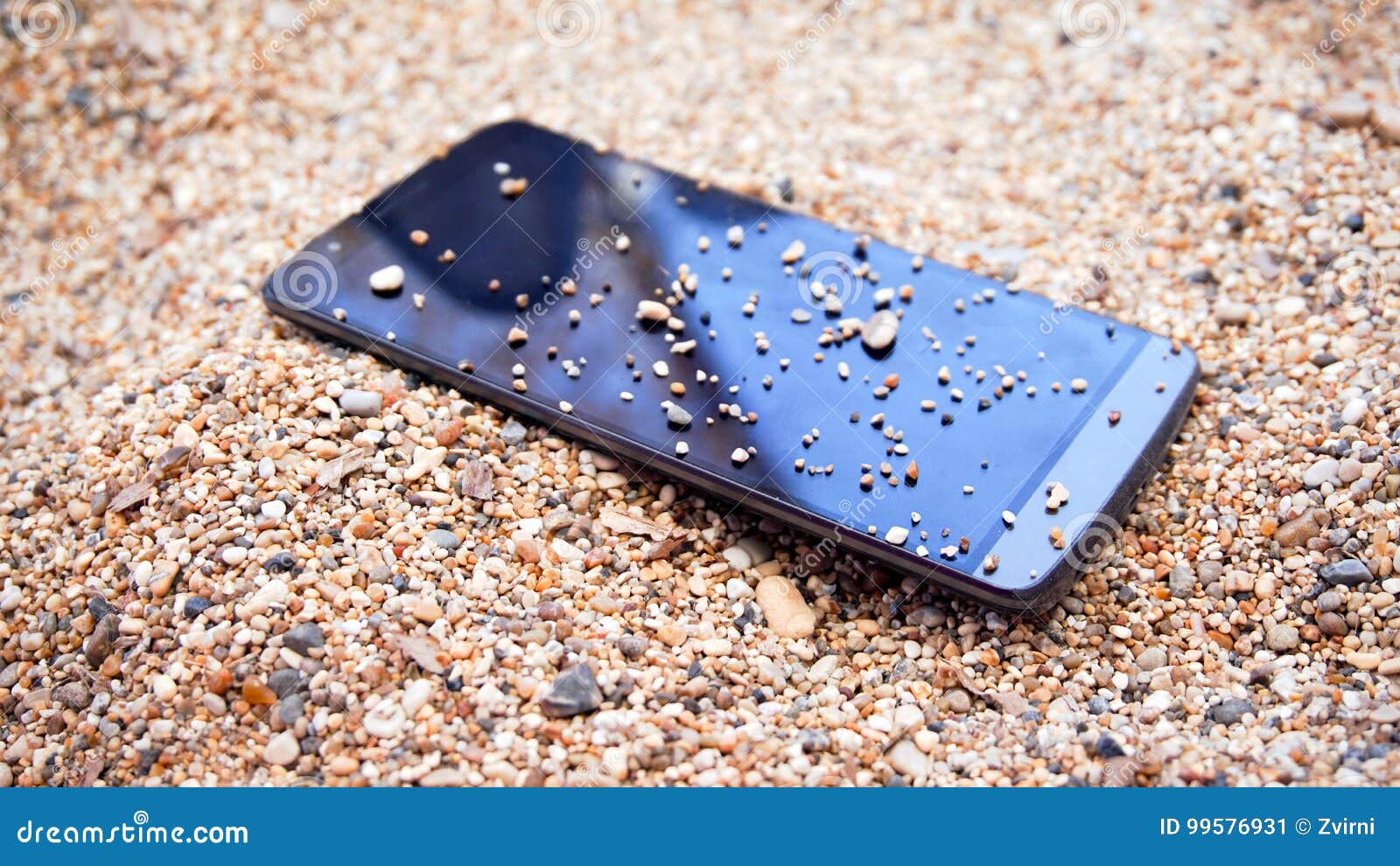 A mobile phone in the sand stock image. Image of modern - 99576931
