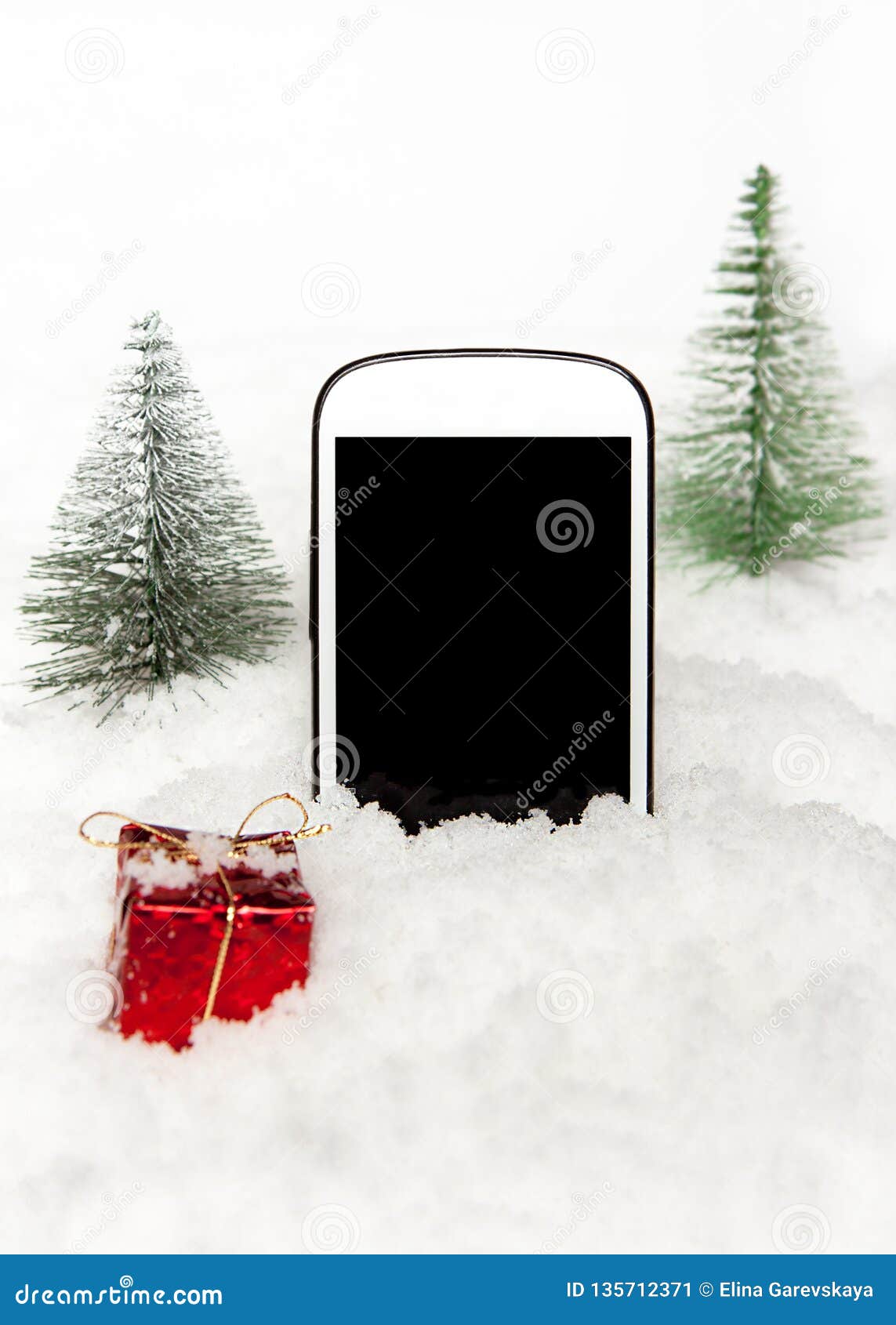 Mobile Phone in the Snow Next To the Gift. Stock Image - Image of cold ...