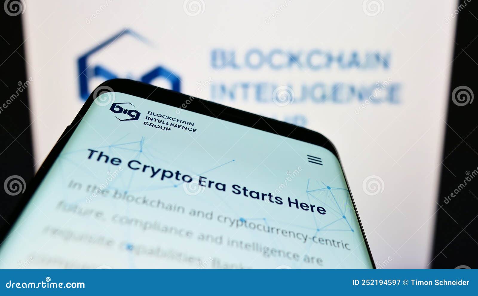 Mobile Phone with Website of Company Blockchain Intelligence Group (BIG) on Screen in Front of ...