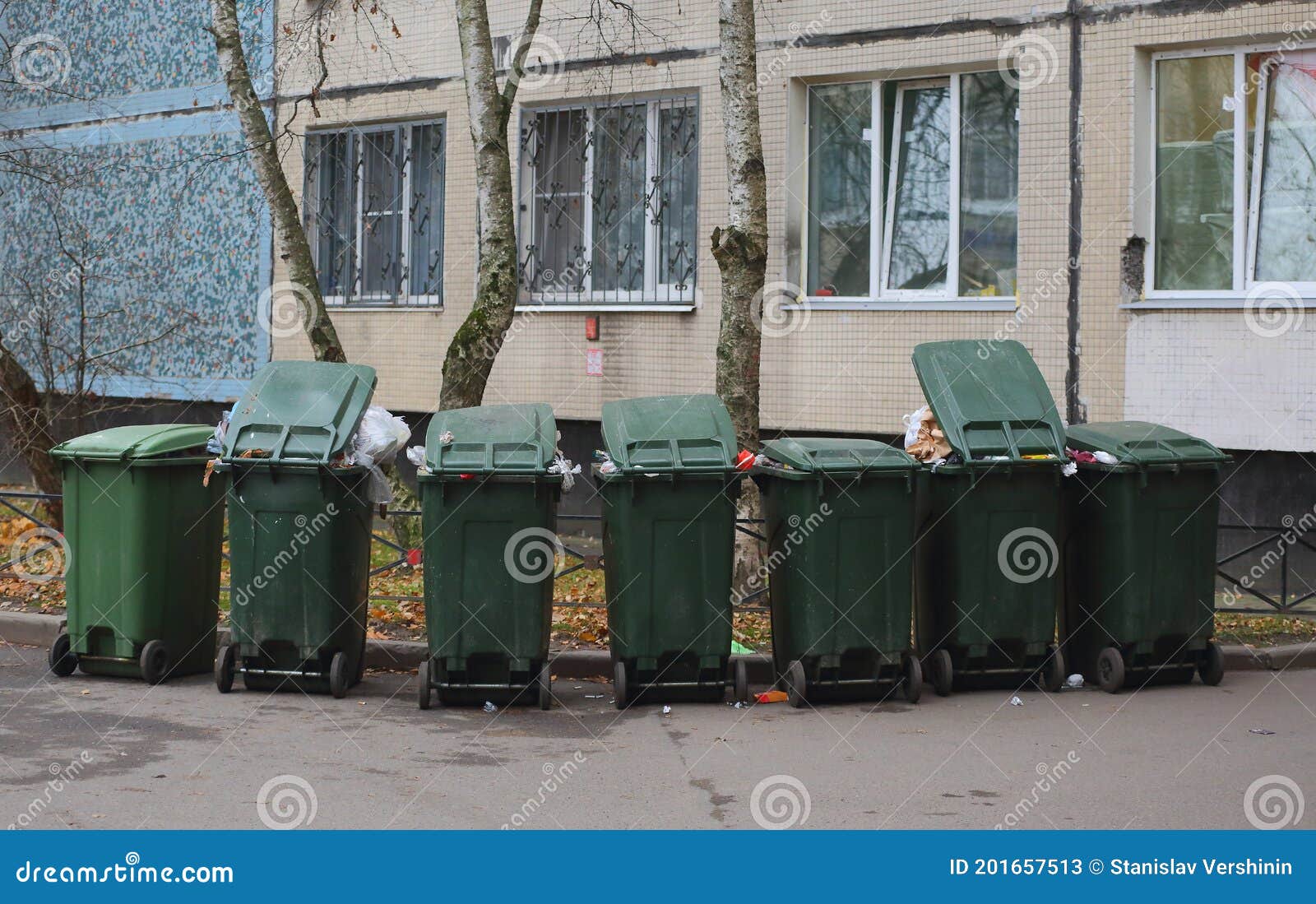 Mobile Plastic Green Garbage Containers Under the Windows of a ...
