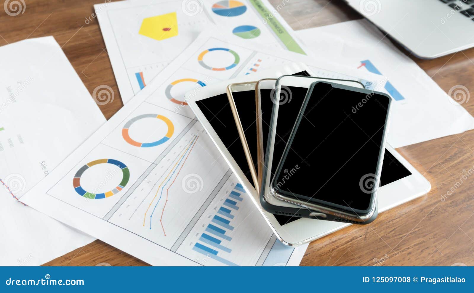 Mobile Smart Phone Stack on the Table with Business Report Background ...