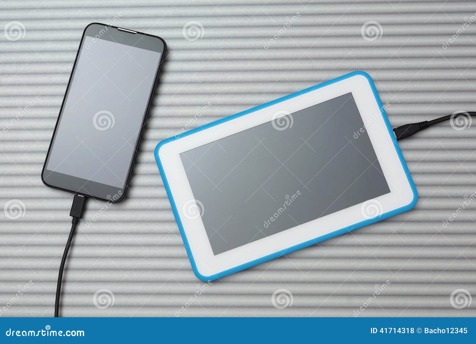 Mobile Smart Phone and Tablet Pc Charging on Silver Desk Stock Photo ...