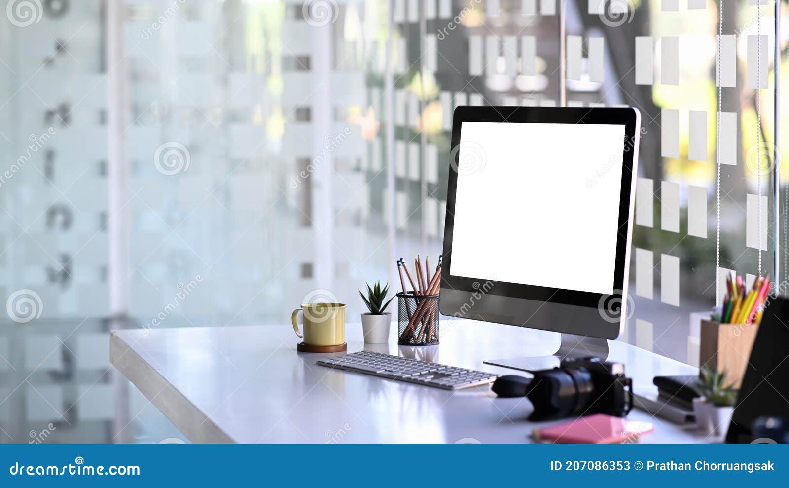 A Computer with White Screen, Camera and Office Supplies on ...