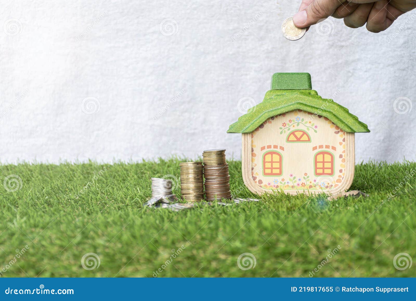 Mock Up House with Coins Stack on Grass Floor and Hand Putting Money ...