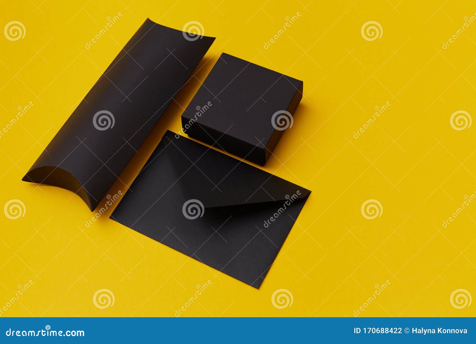 Mock Up of Two Black Paper Present Boxes and an Envelope on the Yellow ...