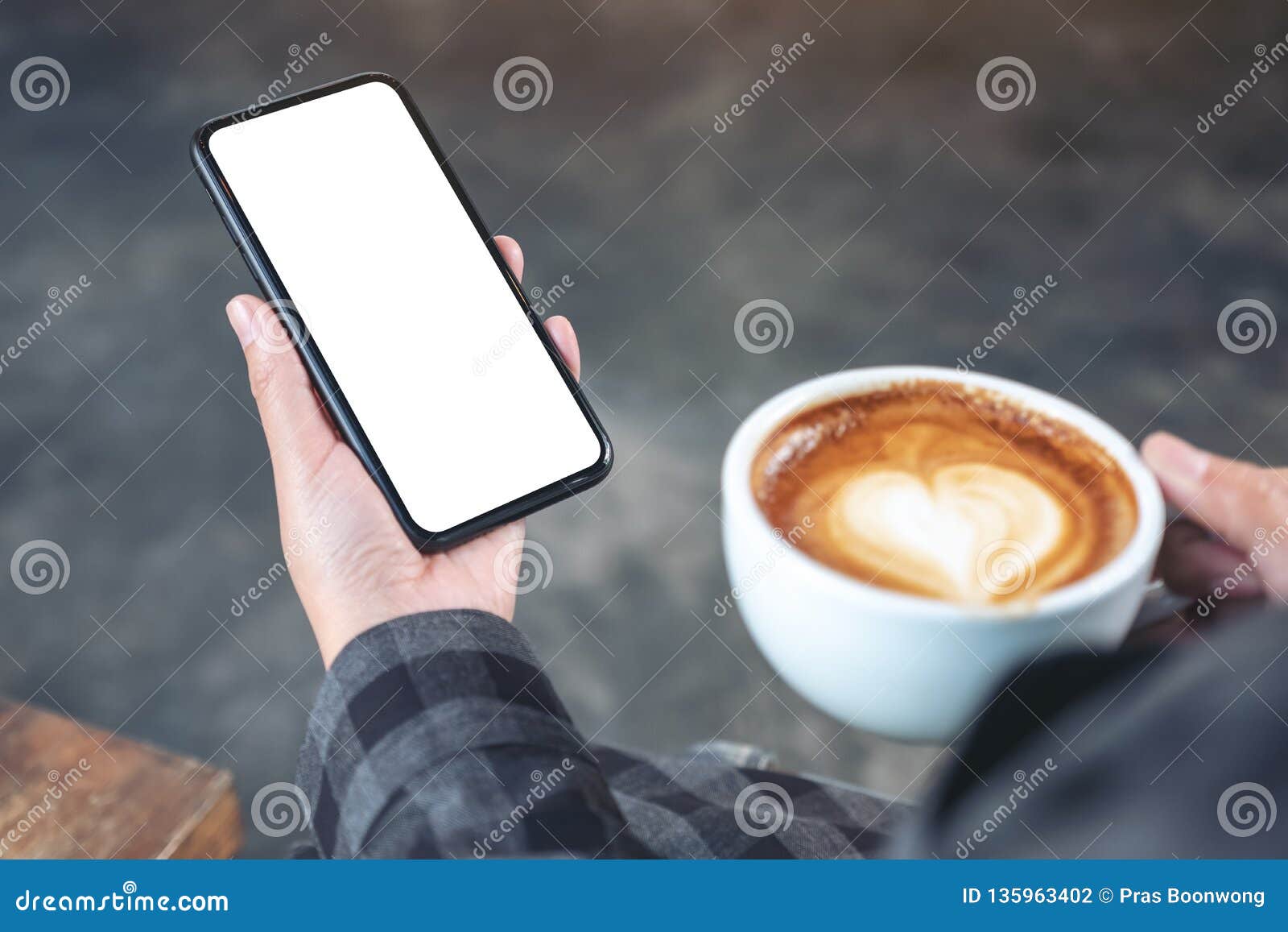 A Hand Holding Black Mobile Phone with Blank Screen while Drinking ...