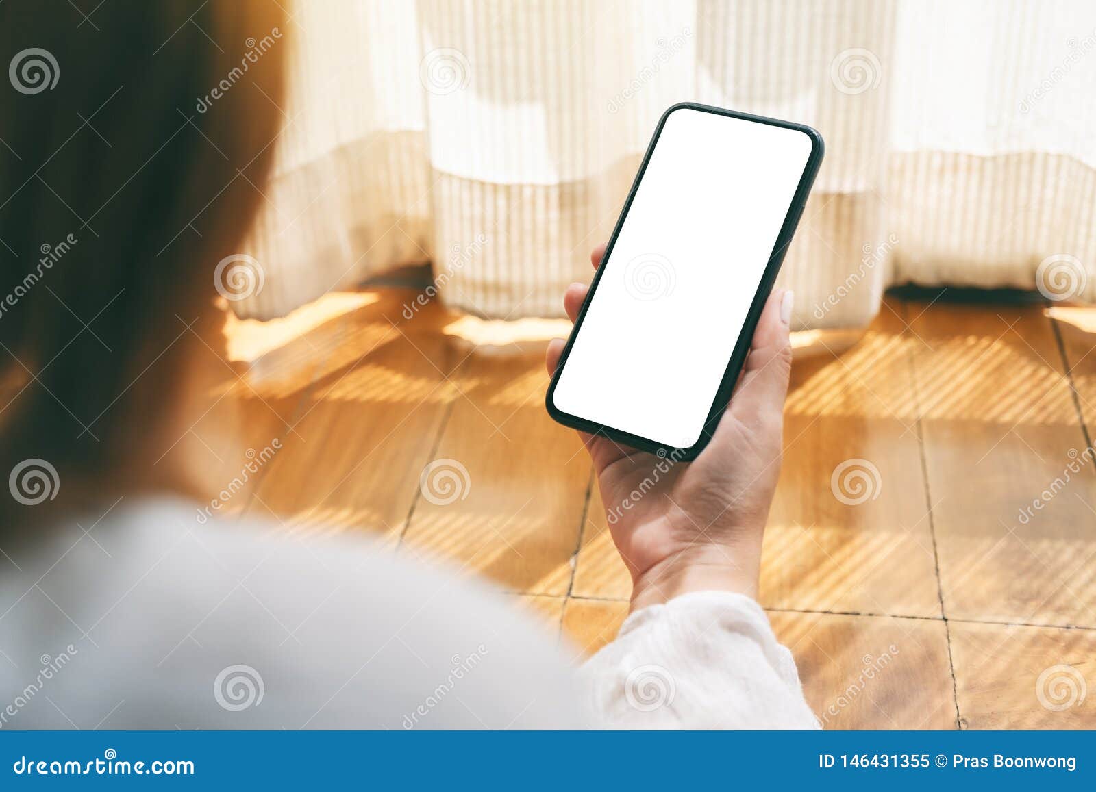 A Woman Holding and Using Black Mobile Phone with Blank Desktop Screen ...