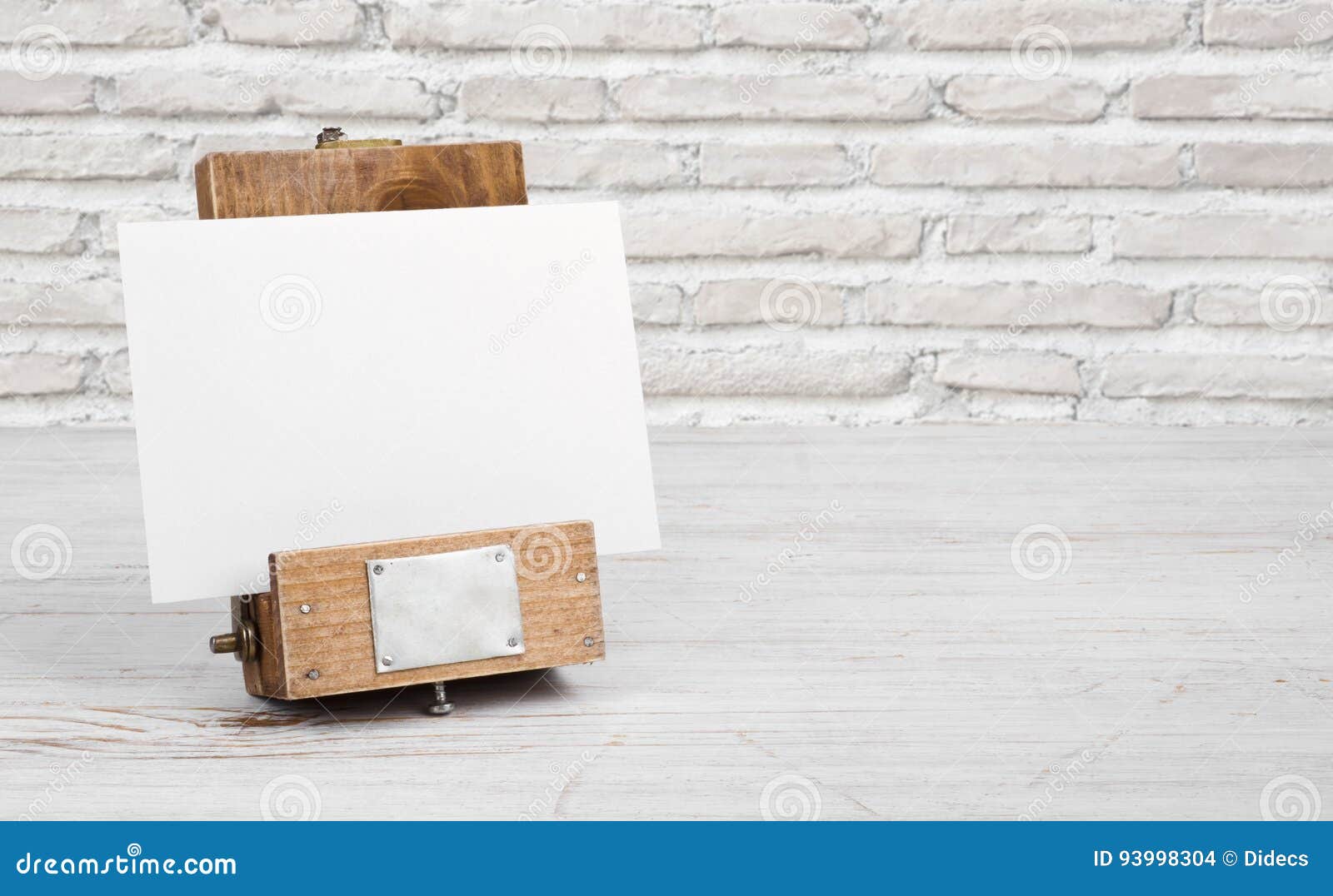 Mockup Stand with Paper on Table Over Abstract Brick Wall Stock Photo ...