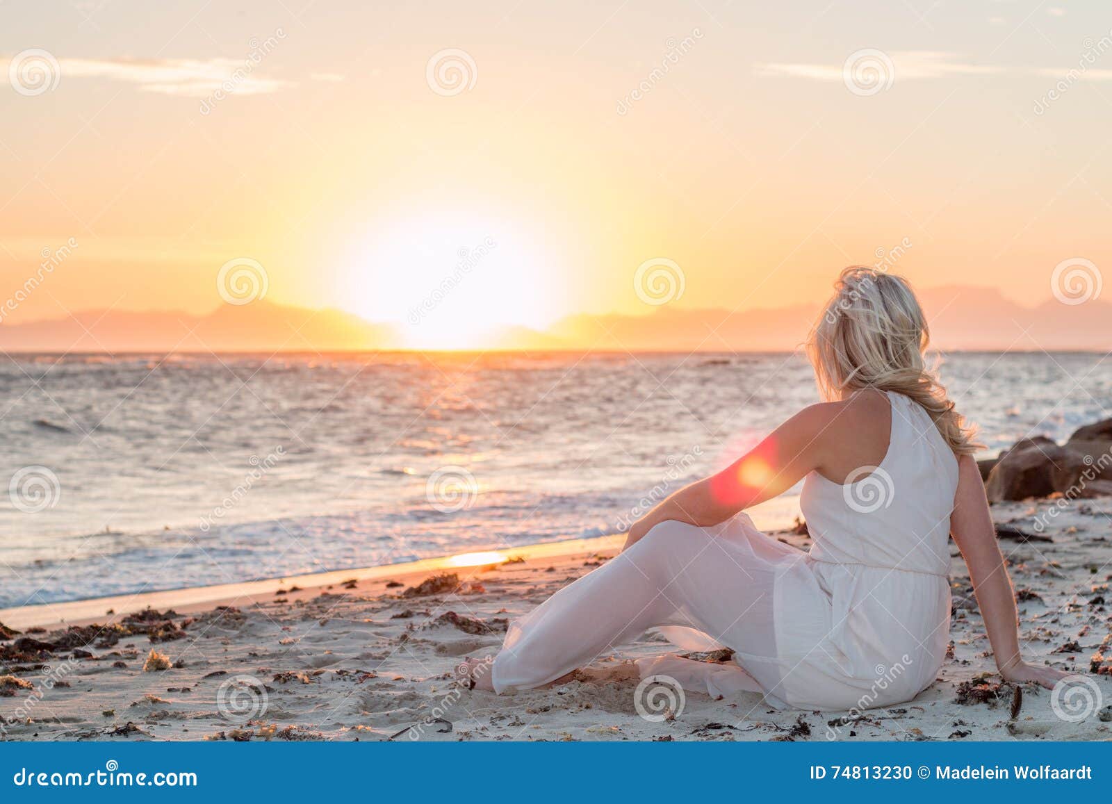 Model on beach at sunset stock photo. Image of mountains - 74813230