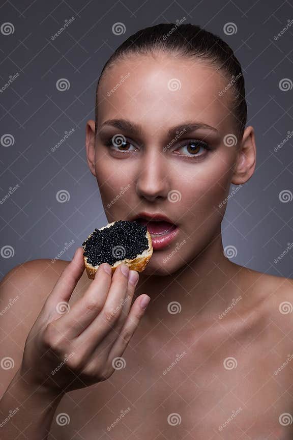 Model Biting Off a Piece of Bread Stock Photo - Image of beads ...