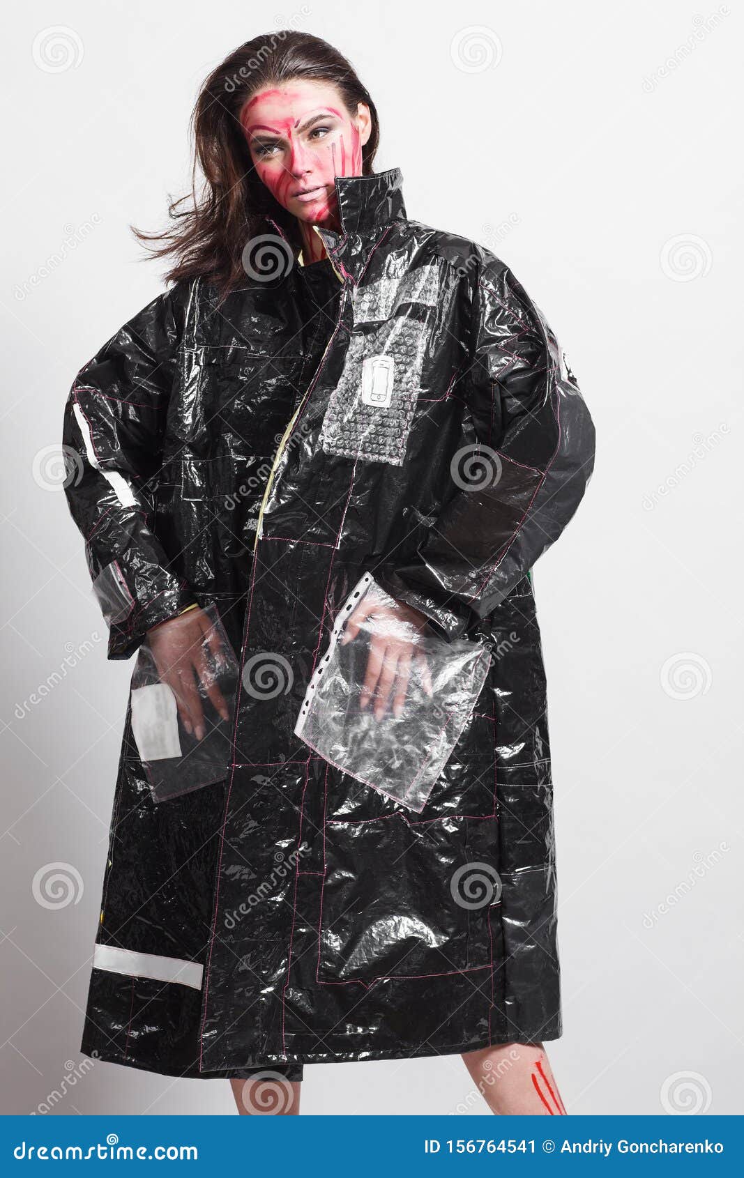 Model in a Black Raincoat Made of Cellophane and in Creative Make-up ...