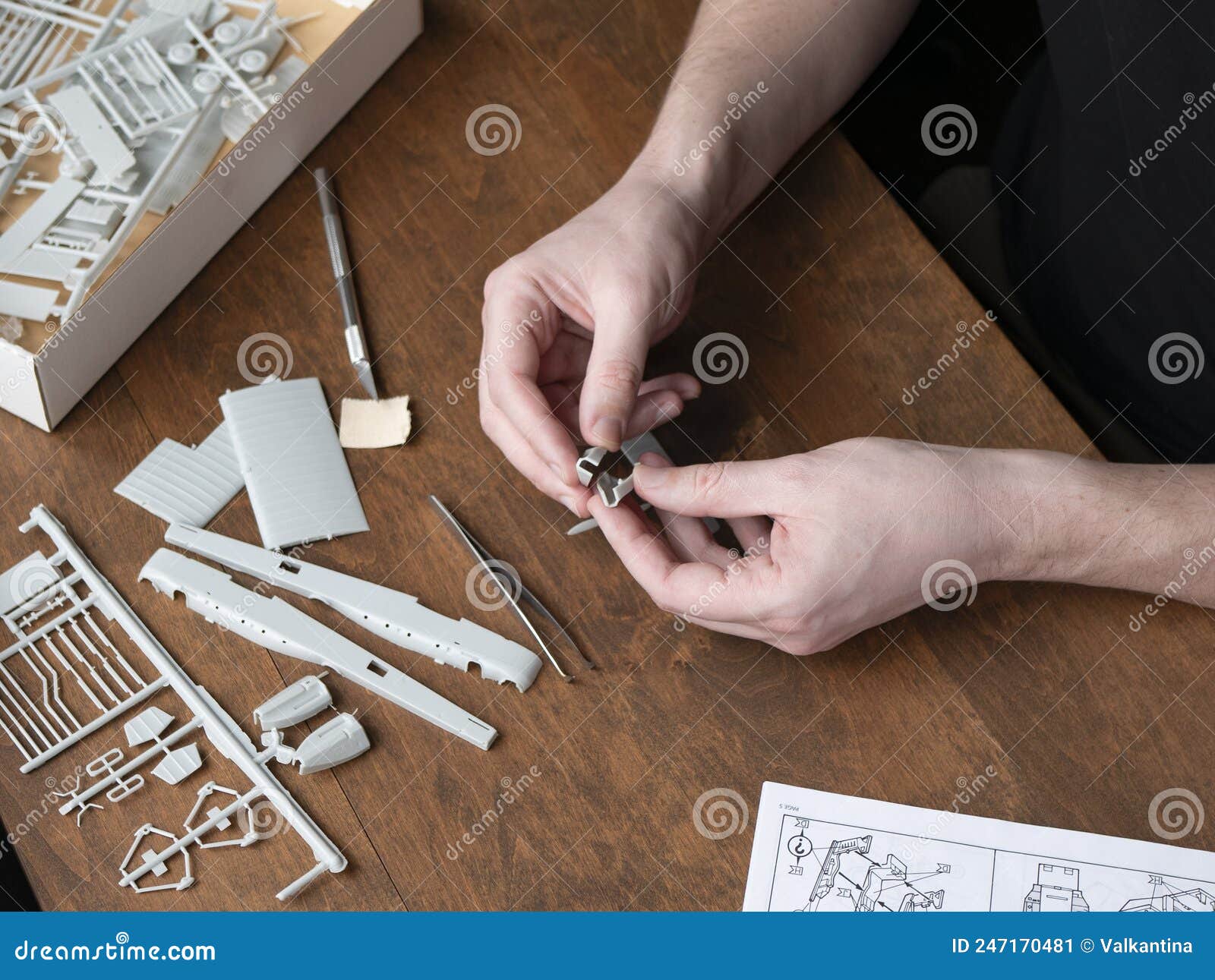 Model Builder Puts Plastic Fuselage Pieces Together. Stage of Plastic ...